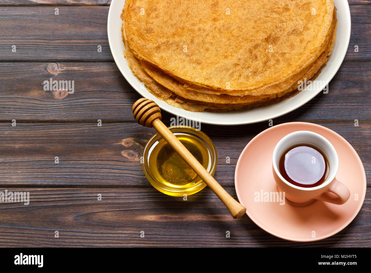breakfast tea with pancakes and honey on wooden background Stock Photo ...