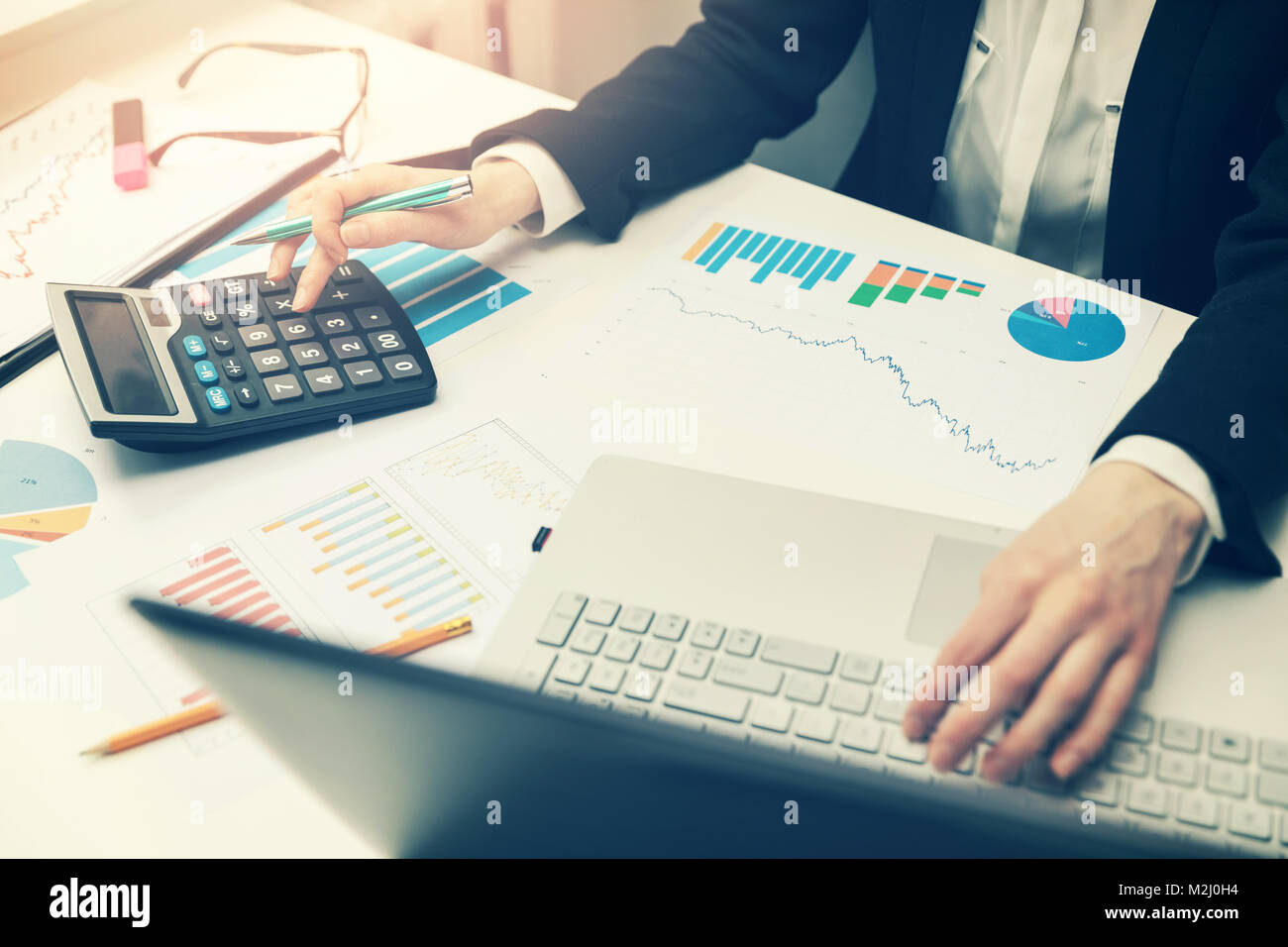 woman working with business reports in office Stock Photo - Alamy