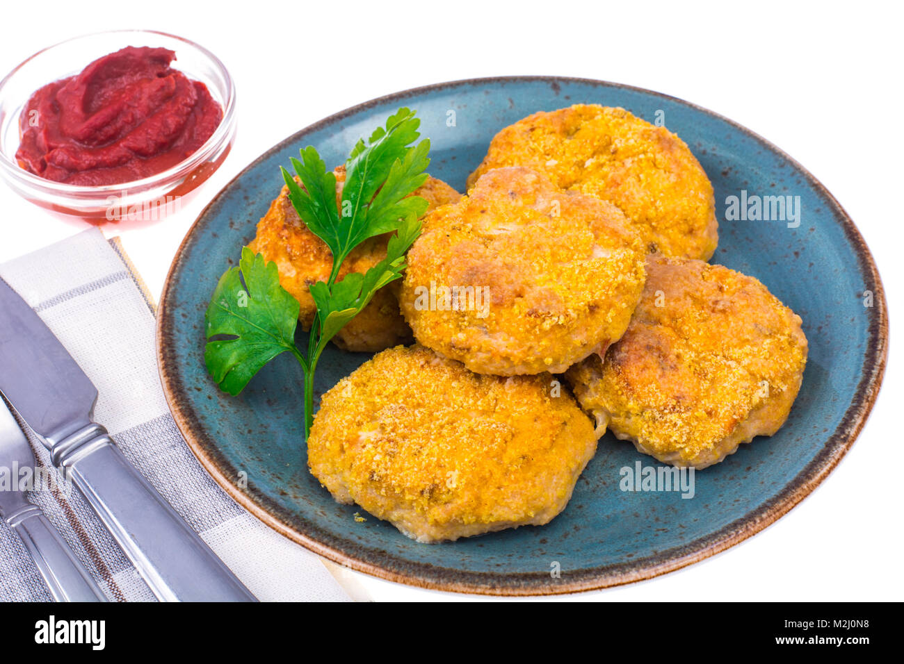 Fish cutlets on blue plate Stock Photo - Alamy