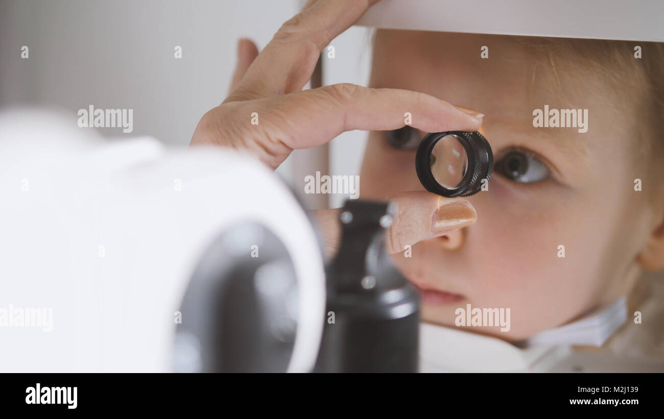 Cute child in ophthalmology clinic - optometrist diagnosis little ...