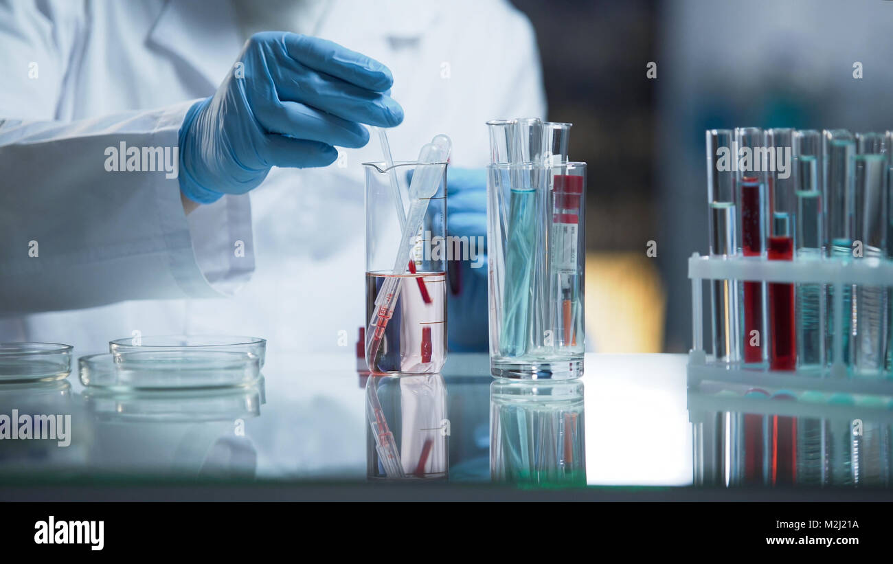 Modern medical laboratory conducting research of blood, experts at work ...
