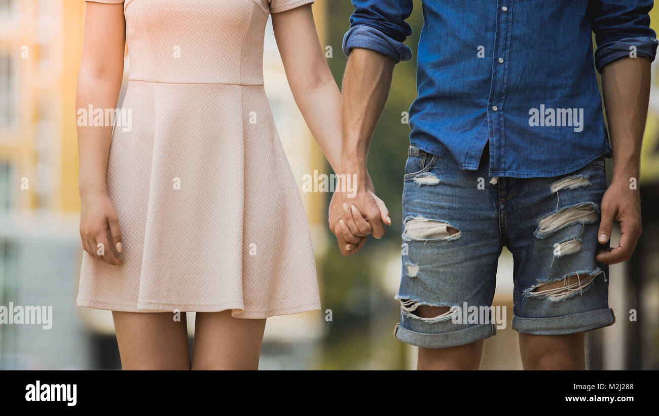 Boyfriend and girlfriend holding each other by hand on date, couple in ...
