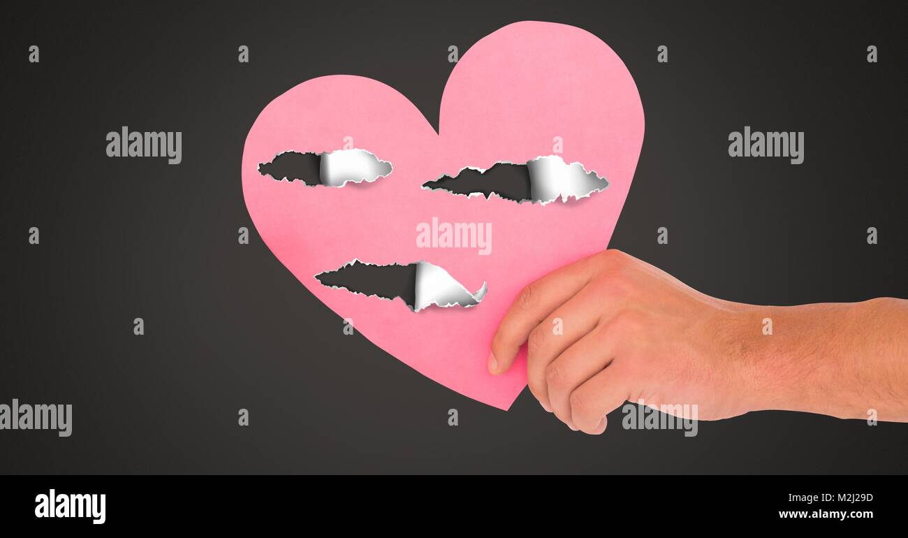 Hand holding hurt love heart with torn paper Stock Photo - Alamy