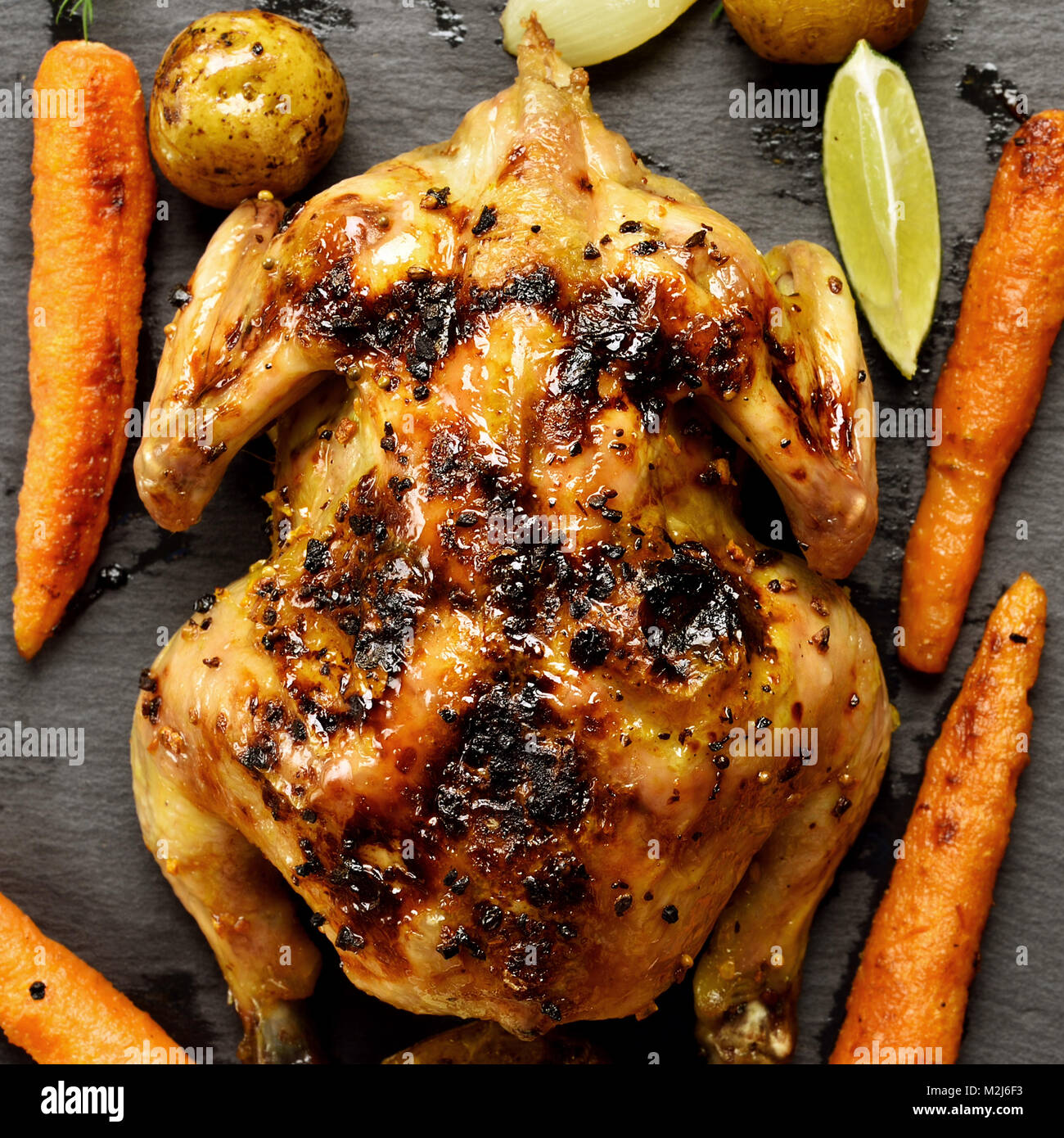 Roasted chicken with vegetables. Top view, close up Stock Photo - Alamy