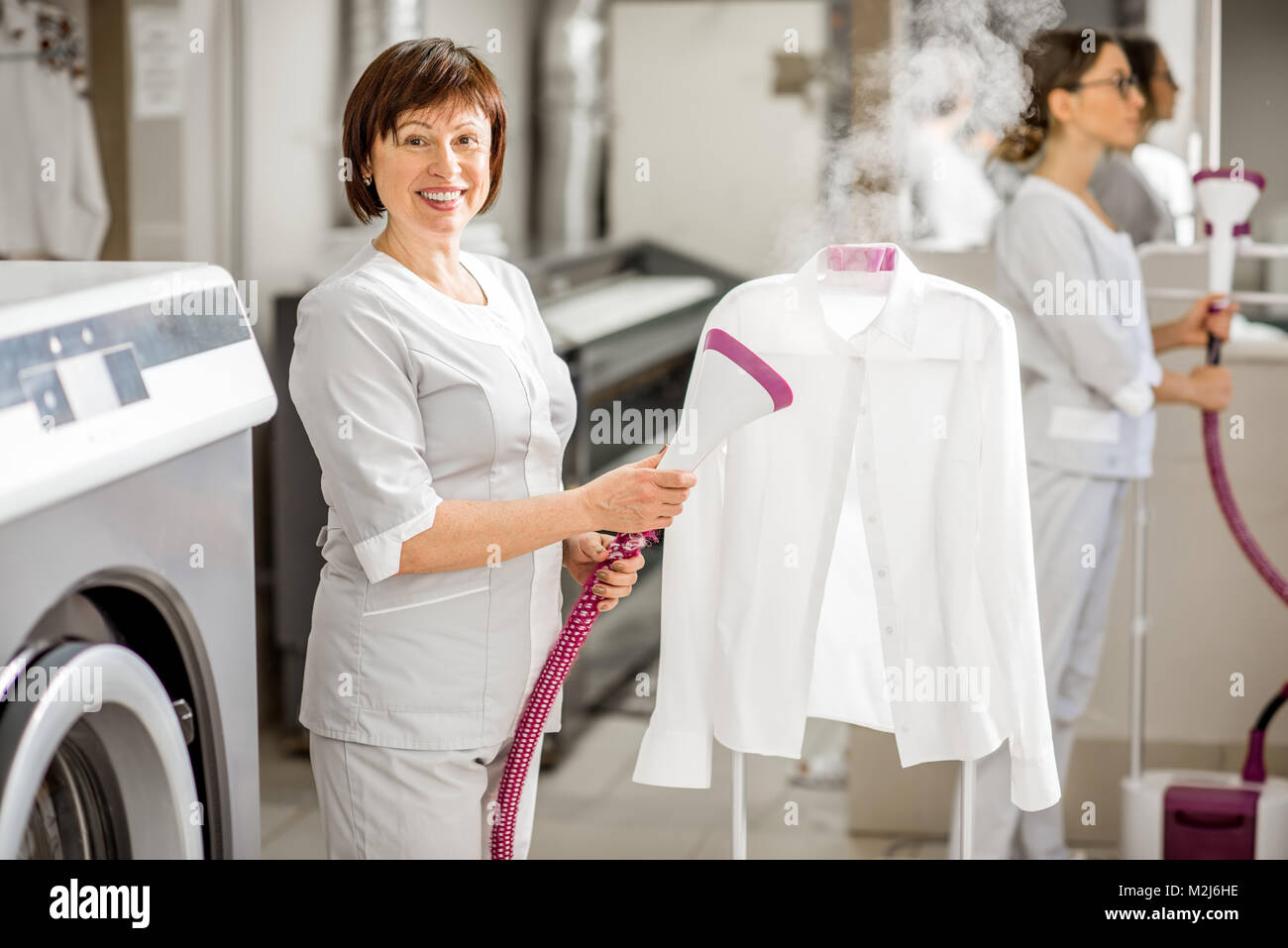 Senior washwoman in the laundry Stock Photo - Alamy