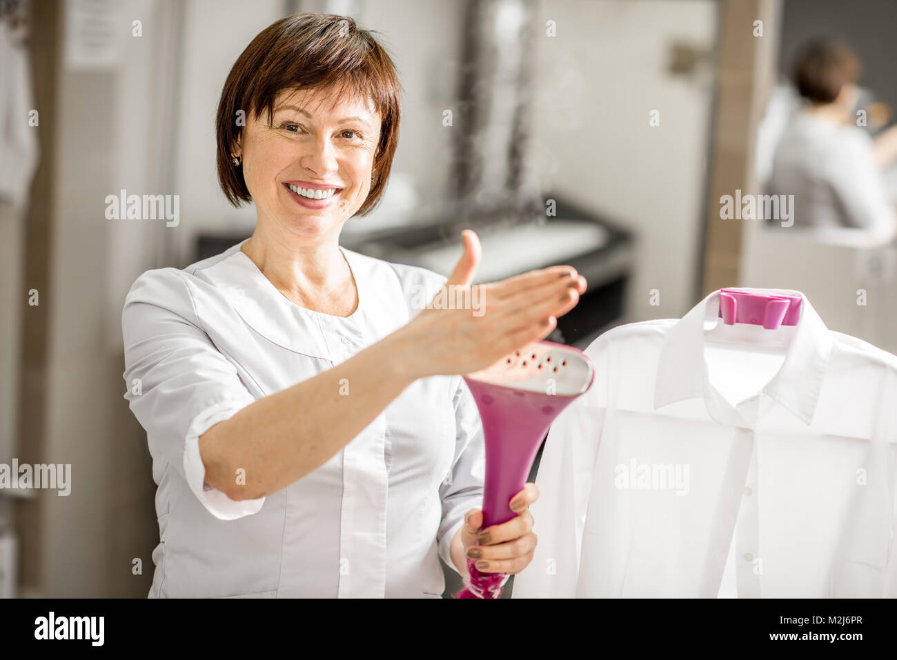 Senior washwoman in the laundry Stock Photo - Alamy
