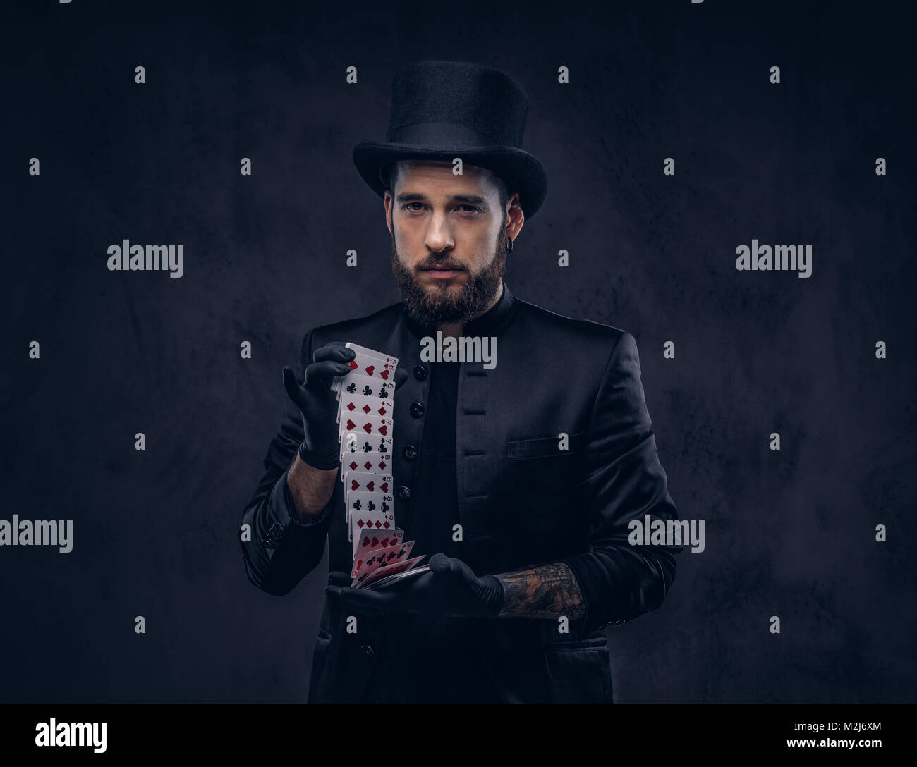 Magician showing trick with playing cards Stock Photo - Alamy
