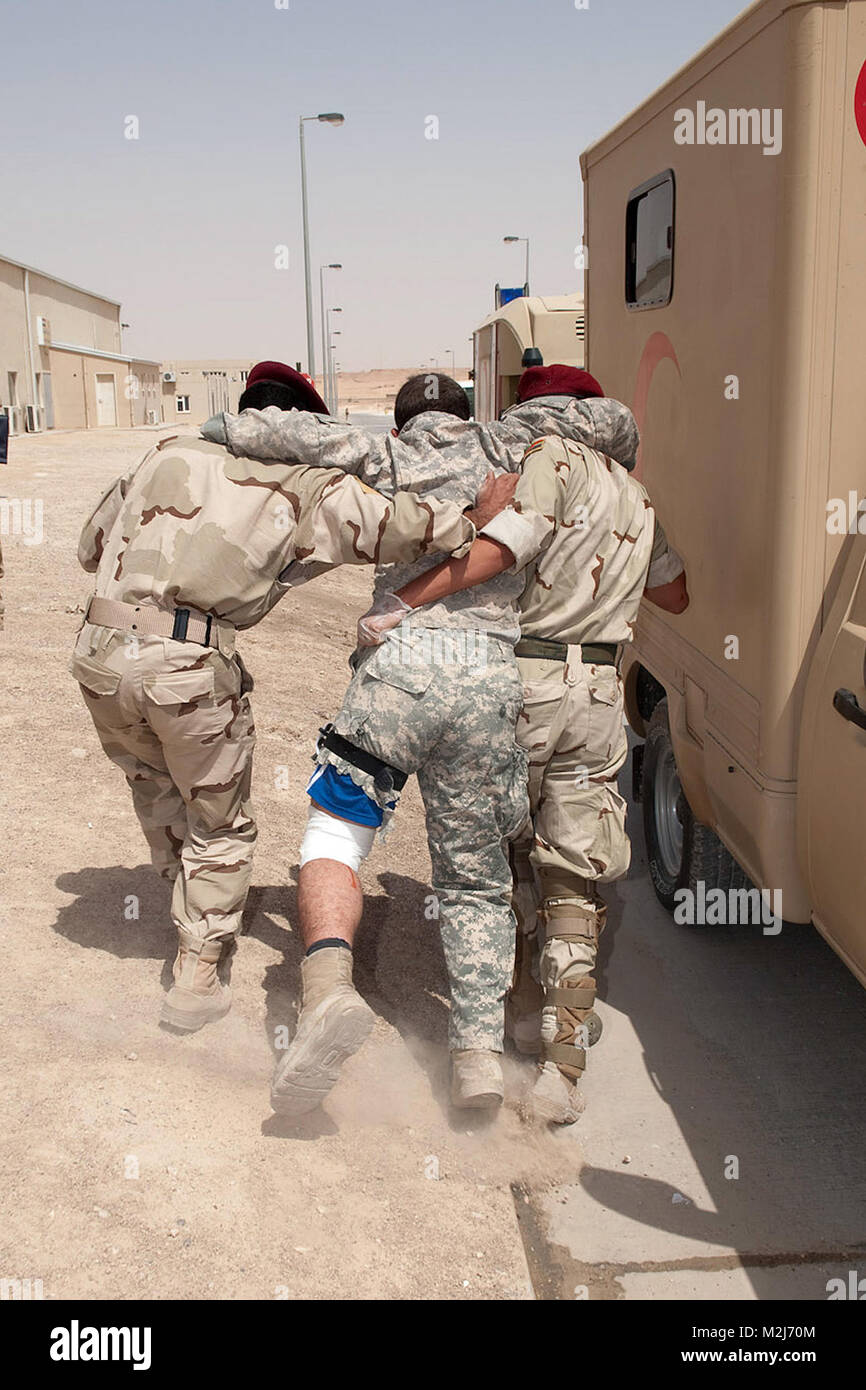 Iraqi medics with 7th Iraqi Army Division carry a wounded soldier to an ...