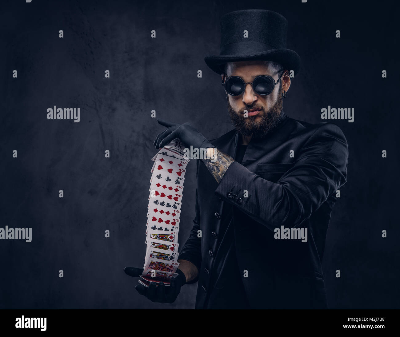 Magician showing trick with playing cards Stock Photo - Alamy
