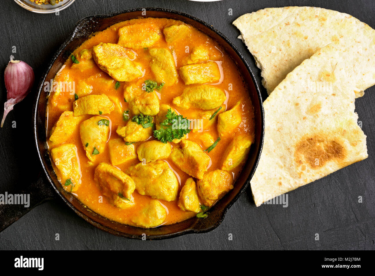 Indian chicken curry on black stone background. Top view, flat lay ...