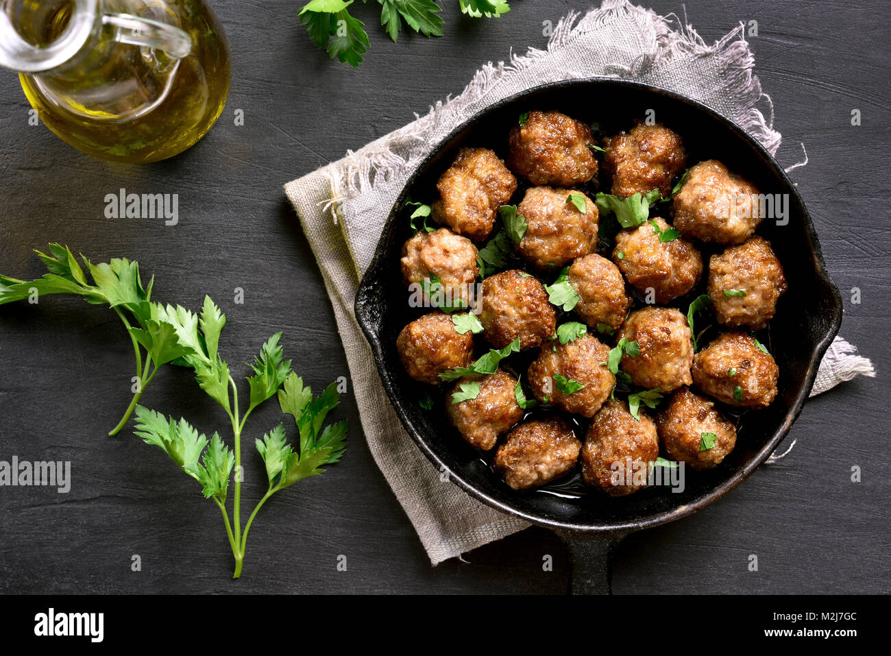 Meatballs in frying pan on black stone background. Top view, flat lay ...