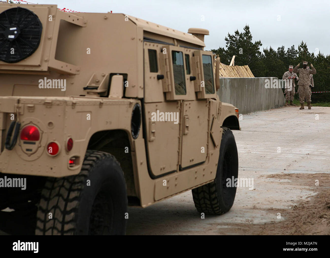 An up-armored HMMWV drives through a recently constructed ramp designed ...