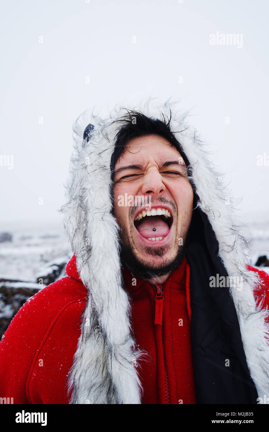 Young man enjoying a snowy day Stock Photo - Alamy