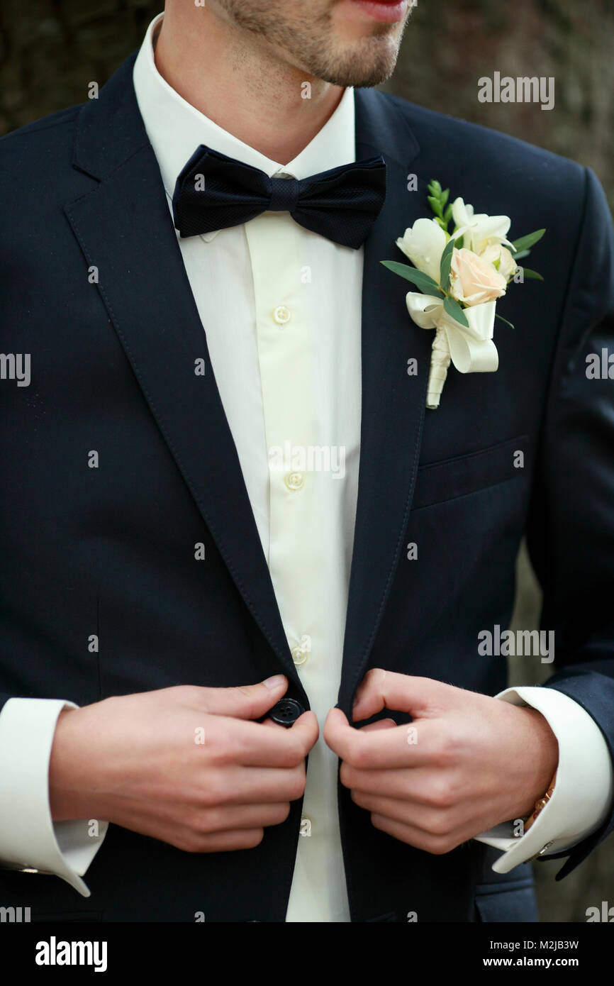Posed groom with button hole.Wedding details, beautiful boutonniere ...