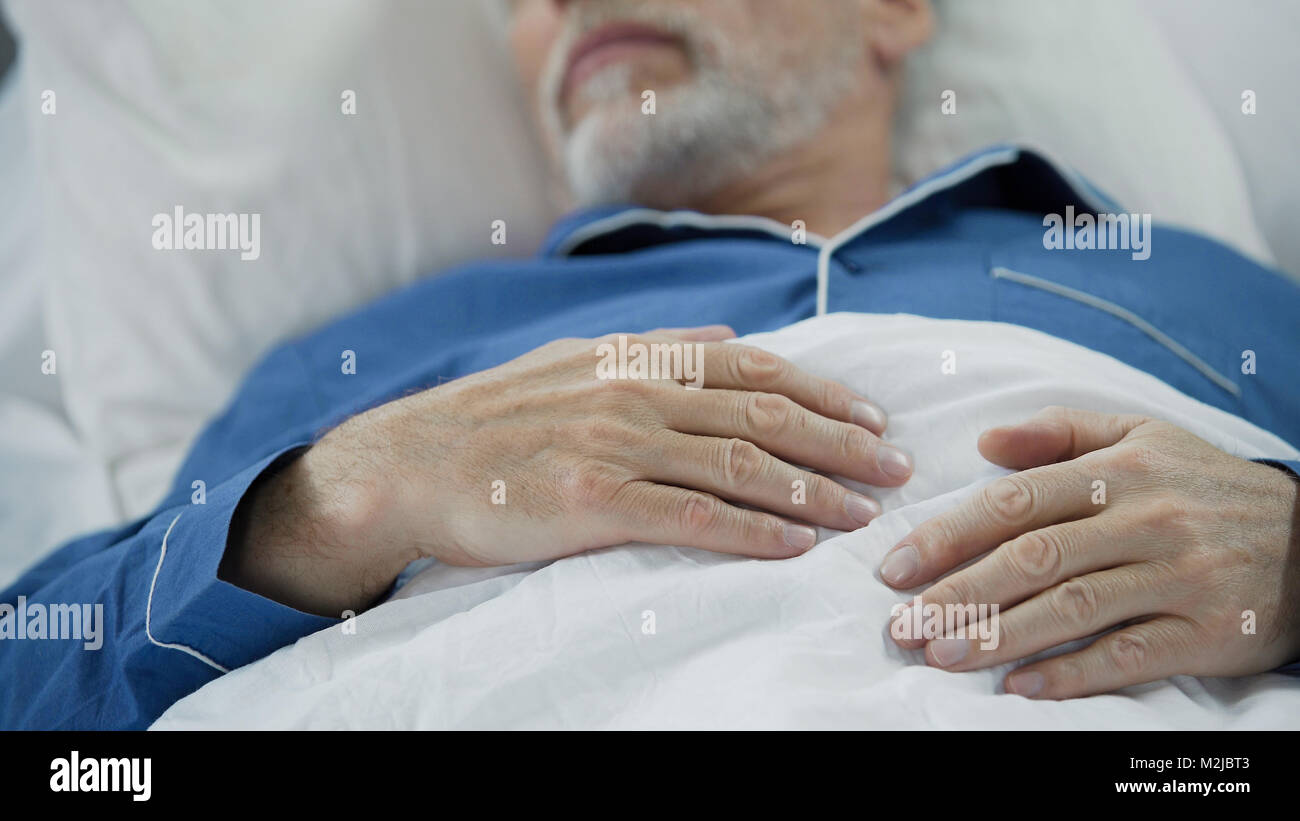 View of overworked wrinkled hands of wise old man peacefully drowsing ...