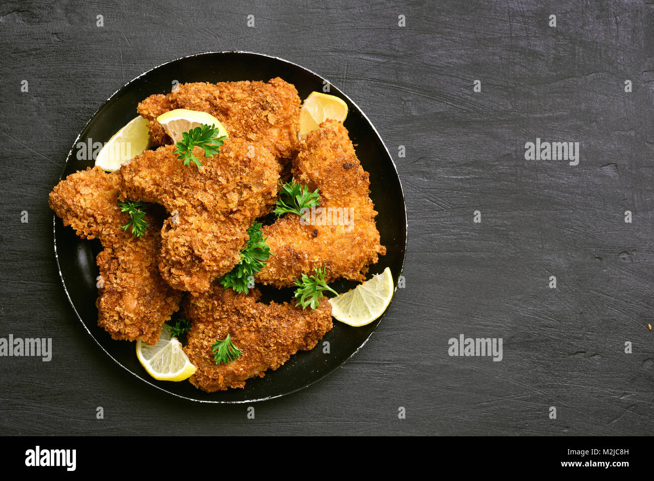 Crispy chicken wings. Dish for dinner on plate over black background ...