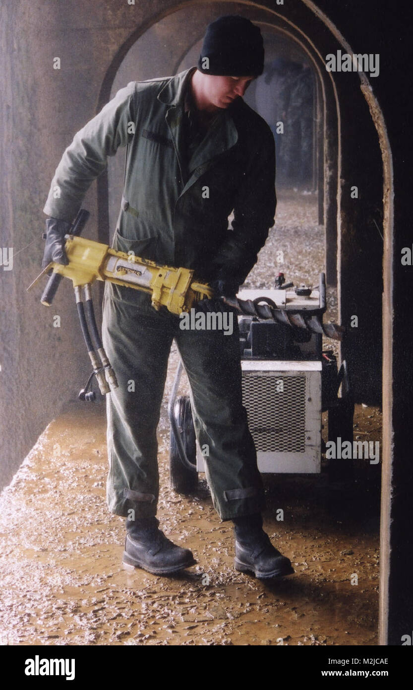 Michael Bachner of the 544th Engineer Dive Team moves a hydraulic drill ...