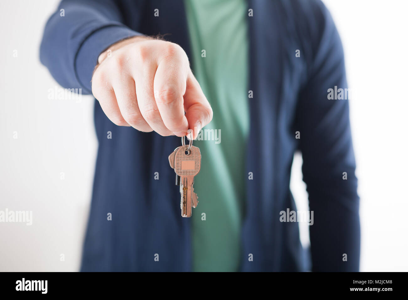 House key in hand Stock Photo - Alamy