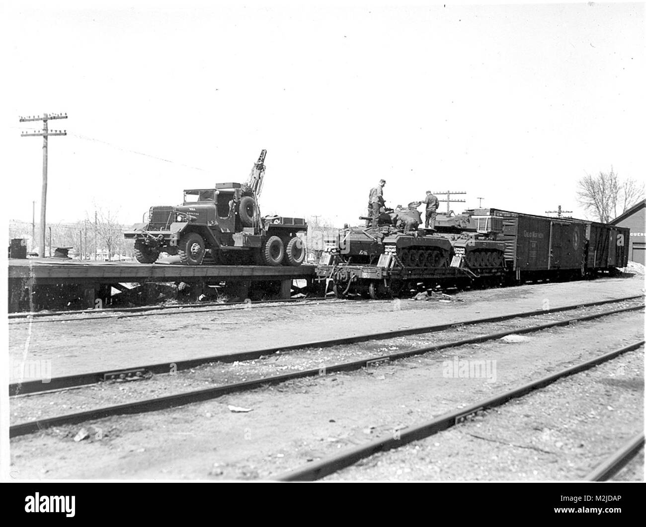 Crews work to line haul two M24 Chaffee from Company D, 115th Cavalry ...