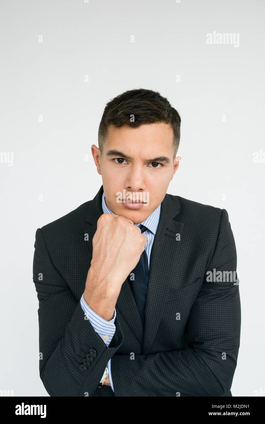 Portrait of an unhappy, grumpy handsome young man looking into camera ...