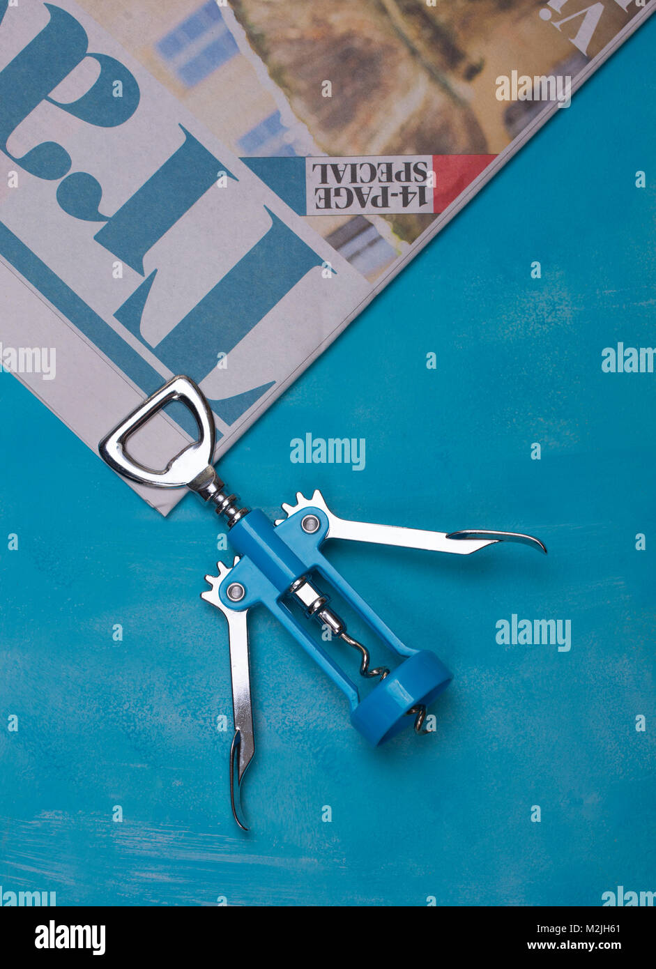 Blue Corkscrew on a blue background with a travel newspaper Stock Photo ...