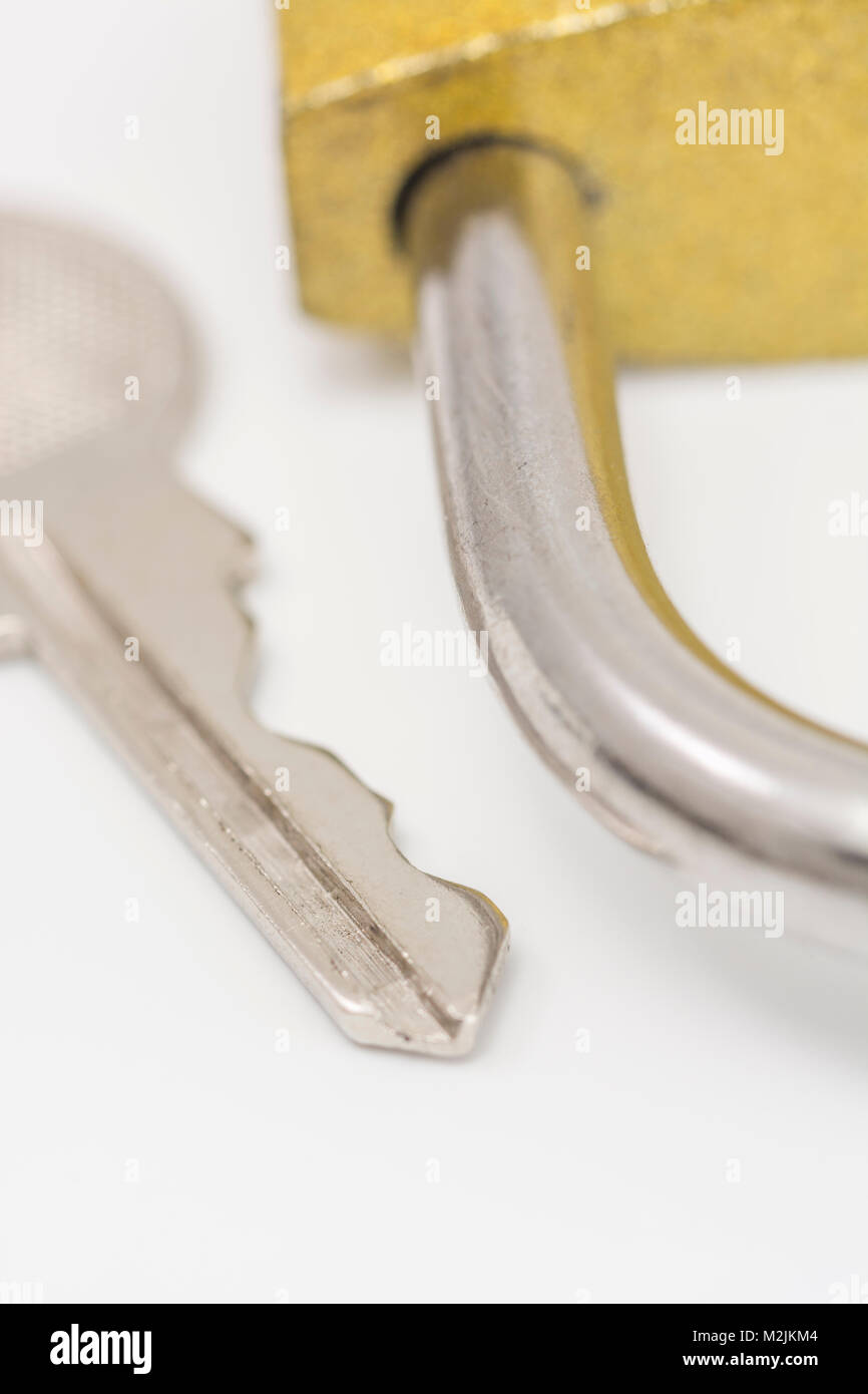 Small padlock on plain background - as visual metaphor for concept of ...