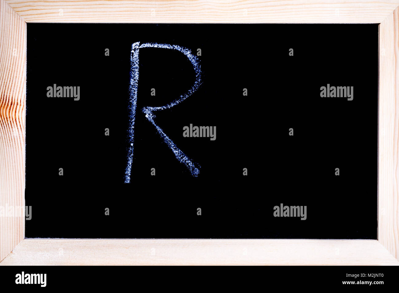 Blackboard with white chalk writing showing capital letter R Stock ...