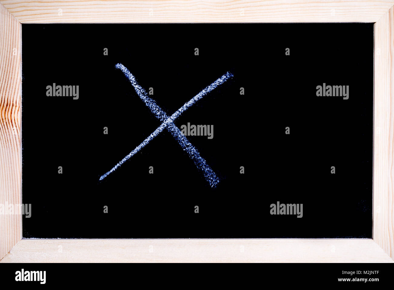 Blackboard with white chalk writing showing capital letter X Stock ...