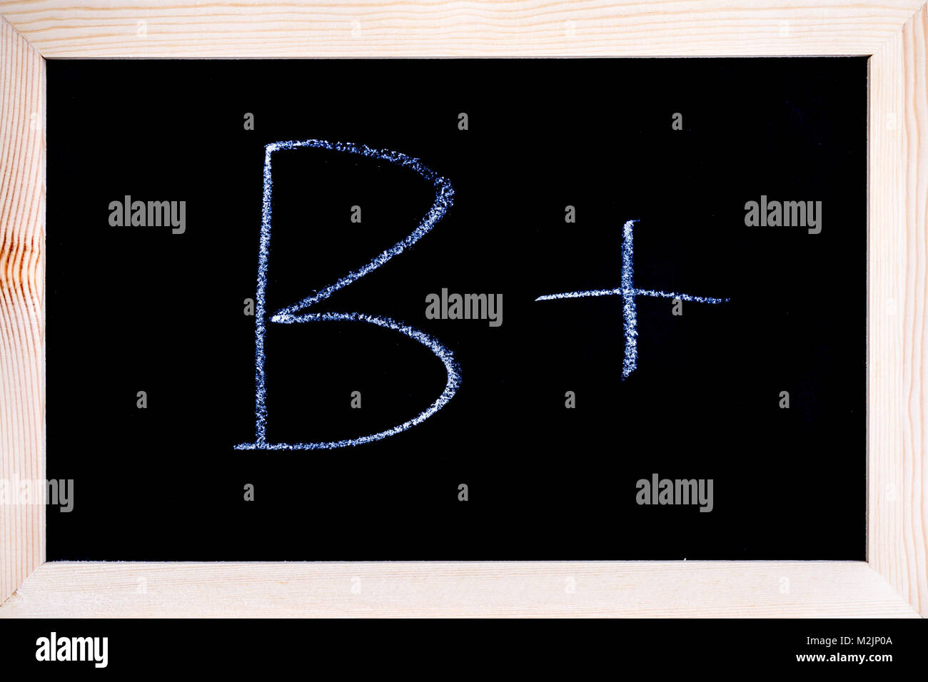 Blackboard with white chalk writing showing grade B+ Stock Photo - Alamy