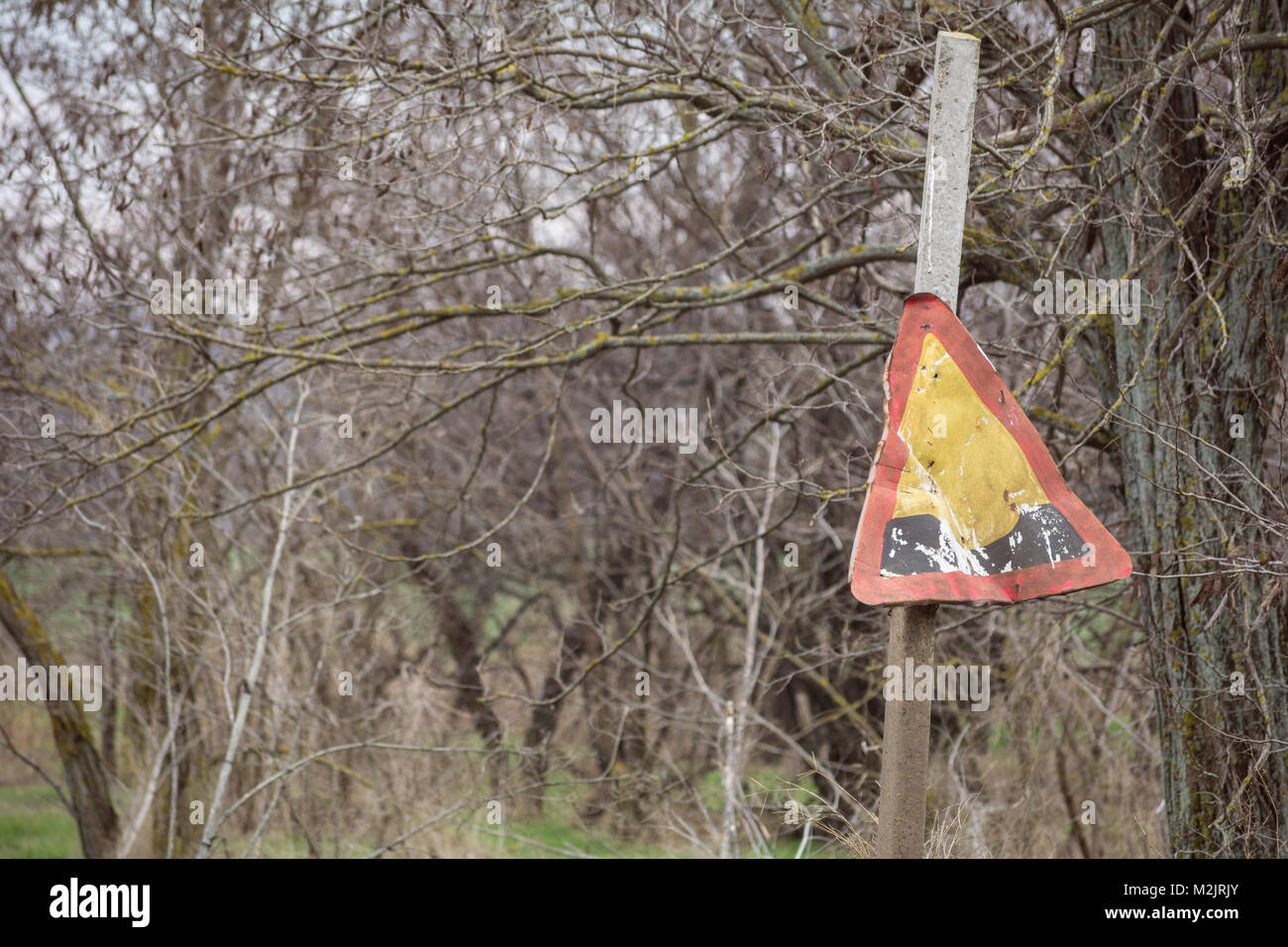 Old yellow-red road sign - Caution pits Stock Photo - Alamy