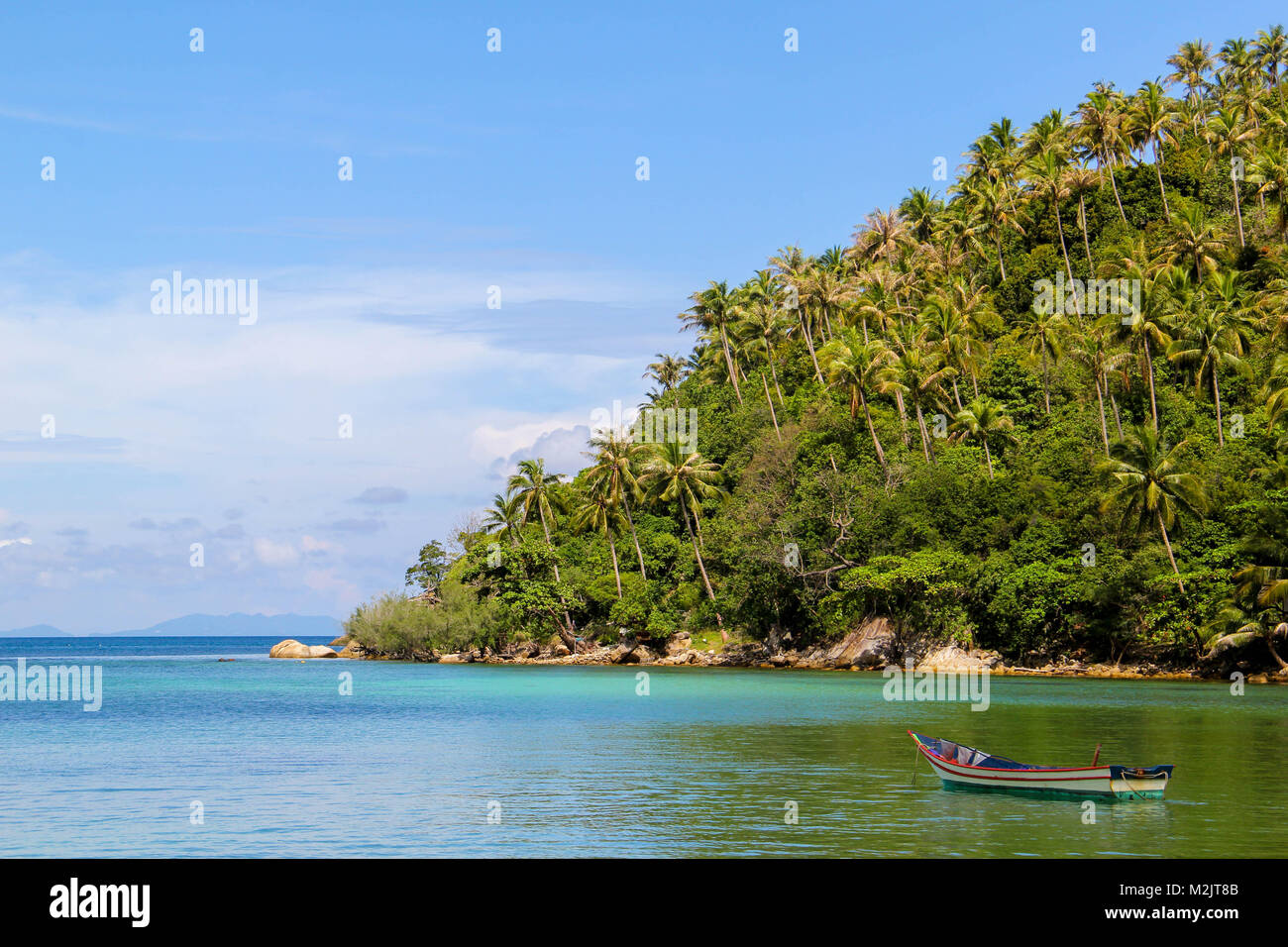 Boat in front of a island Stock Photo - Alamy