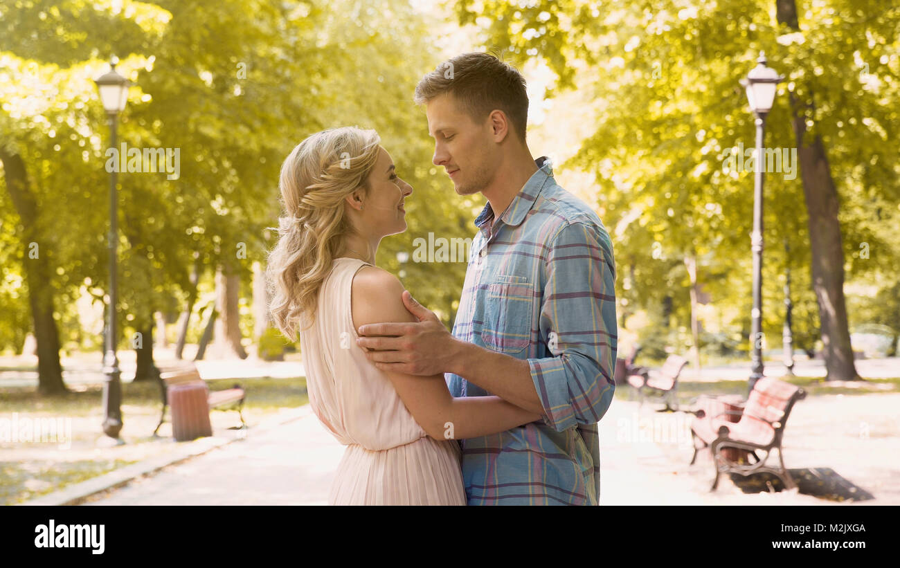 Loving couple gently embracing, enjoying long-awaited date in park ...