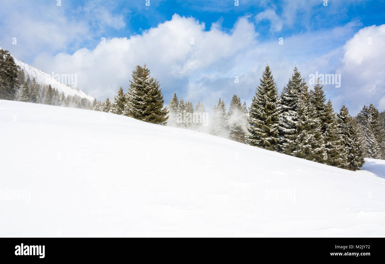 winter landscape in a mountain valley with snow. Dramatic overcast sky ...
