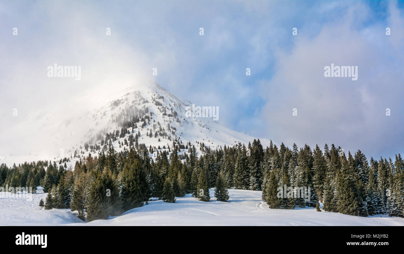 winter landscape in a mountain valley with snow. Dramatic overcast sky ...