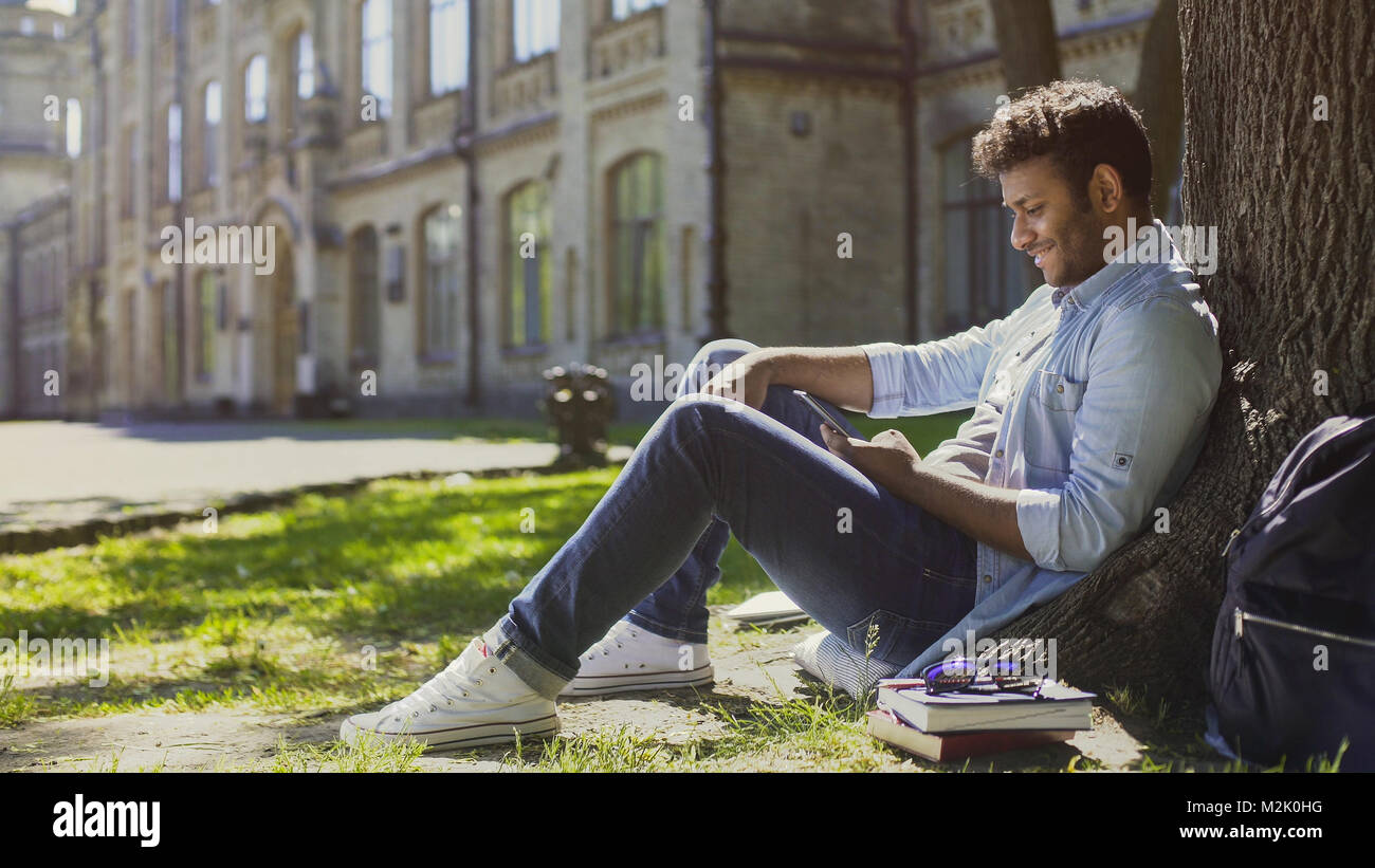 Man sitting under tree hi-res stock photography and images - Alamy