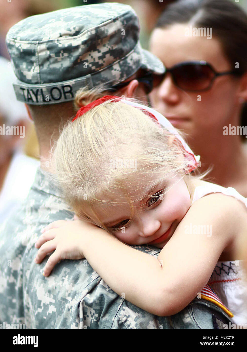 Three-year-old Ryann Taylor clings to her father, Staff Sgt. George ...