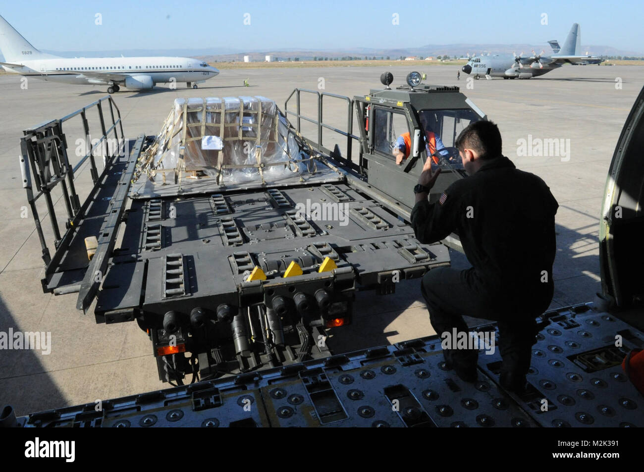 VR-52 sailors load fire fighting equipment onto plane by EUCOM Stock ...