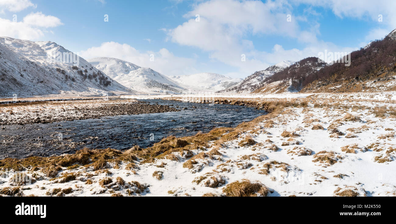 The River Findhorn winding through the Findhorn valley below the snow ...