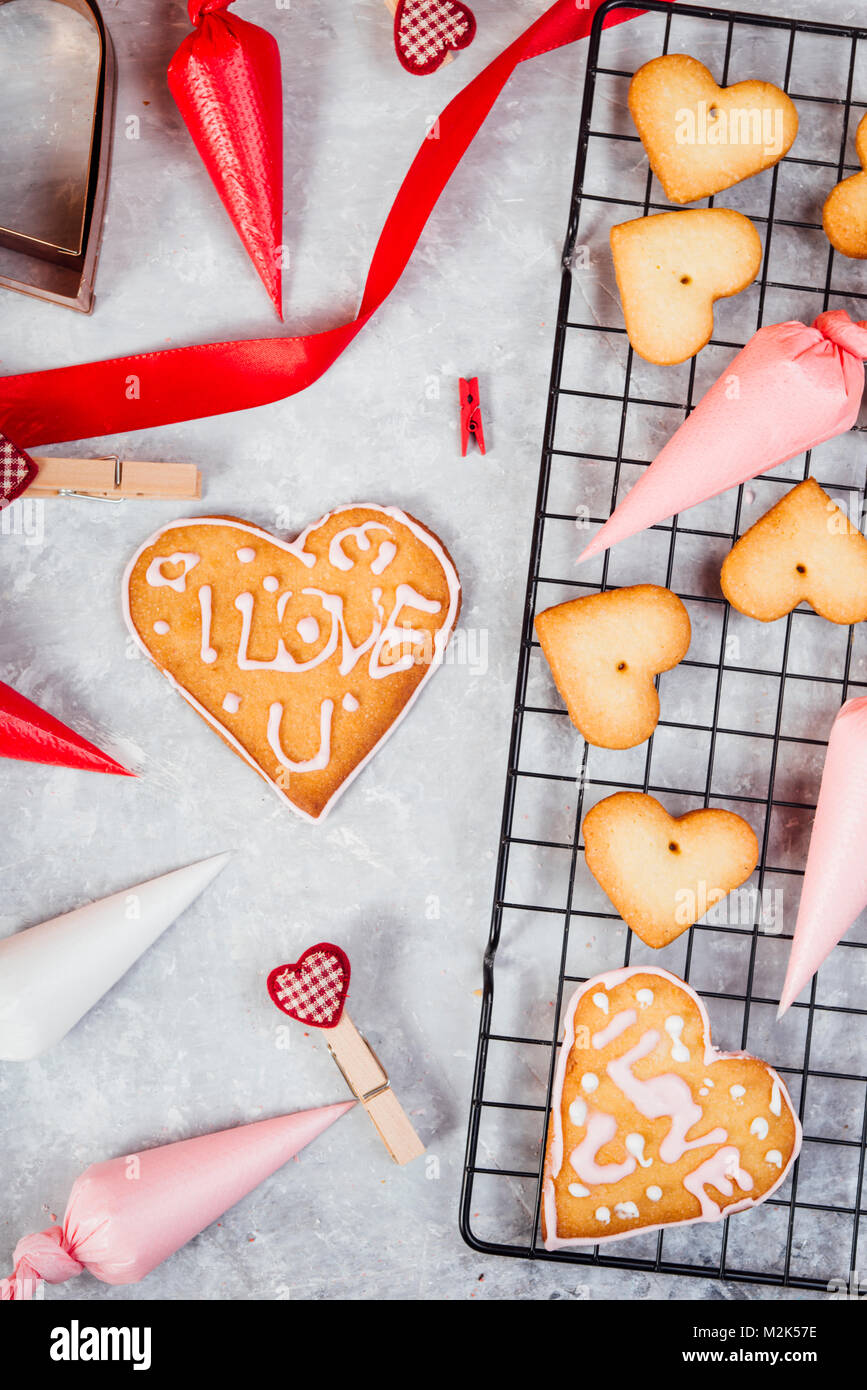 Baking Heart Shaped Cookies for valentine's day, with colored piping ...