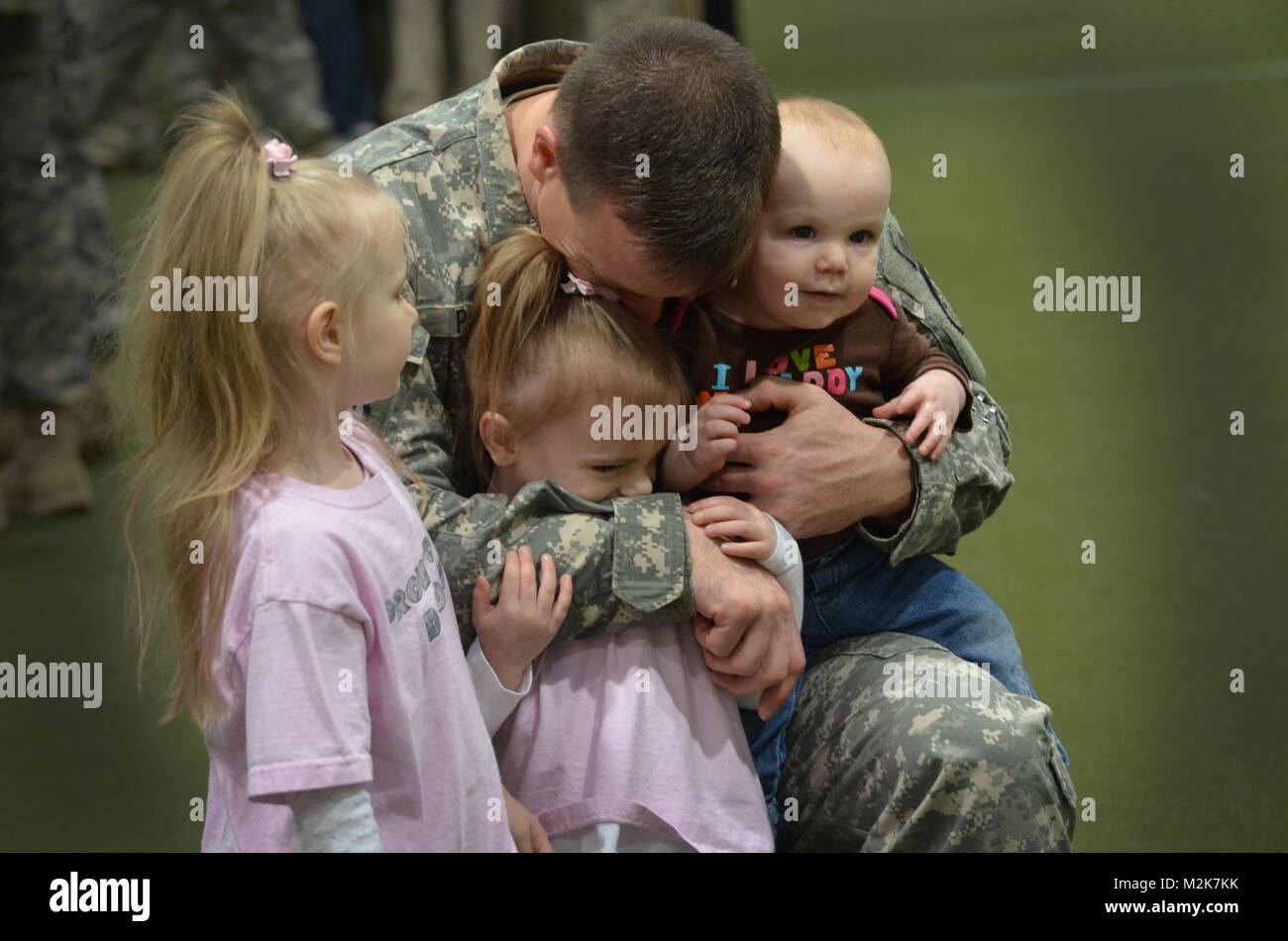 SFC William Petit hugs his children at a deployment ceremony for the ...
