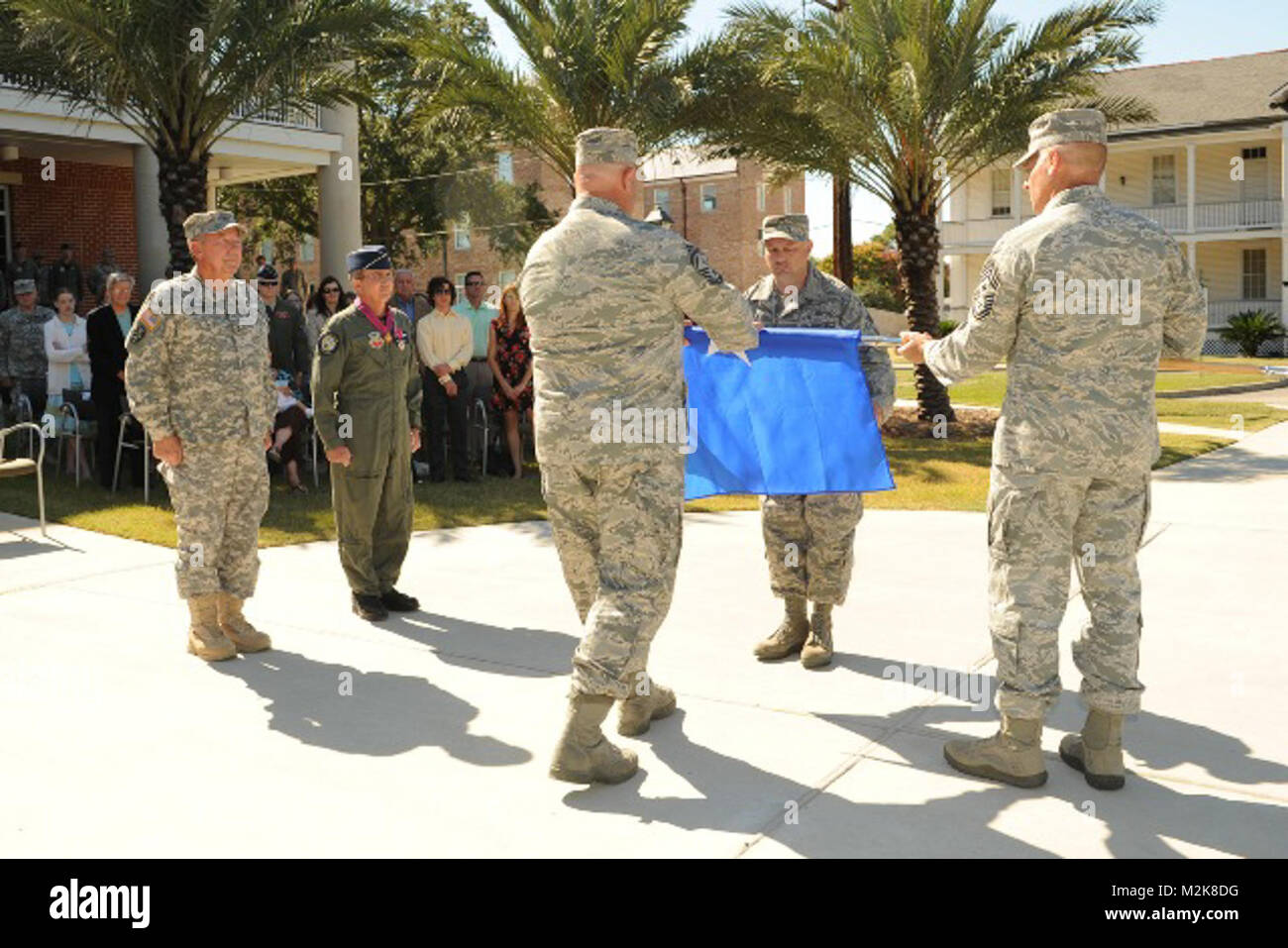 Members of the 159 Fighter Wing furl the one star flag during the ...