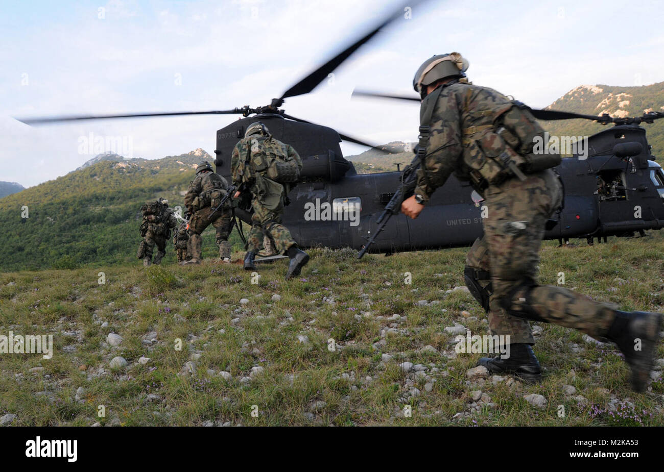 Members of a special operations assault team from Poland dashes to the ...