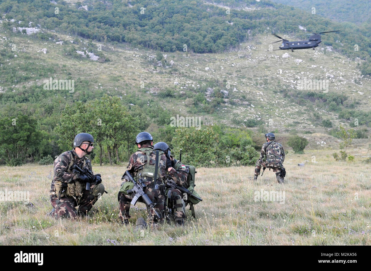 Members of a special operations assault team from Hungary huddles in a ...