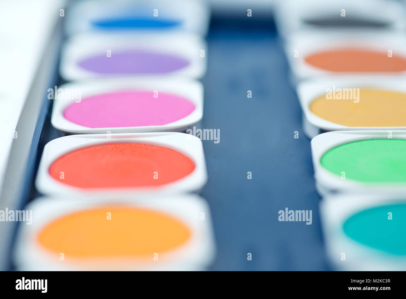 A bright palette of watercolor paints, high key lighting and shallow ...