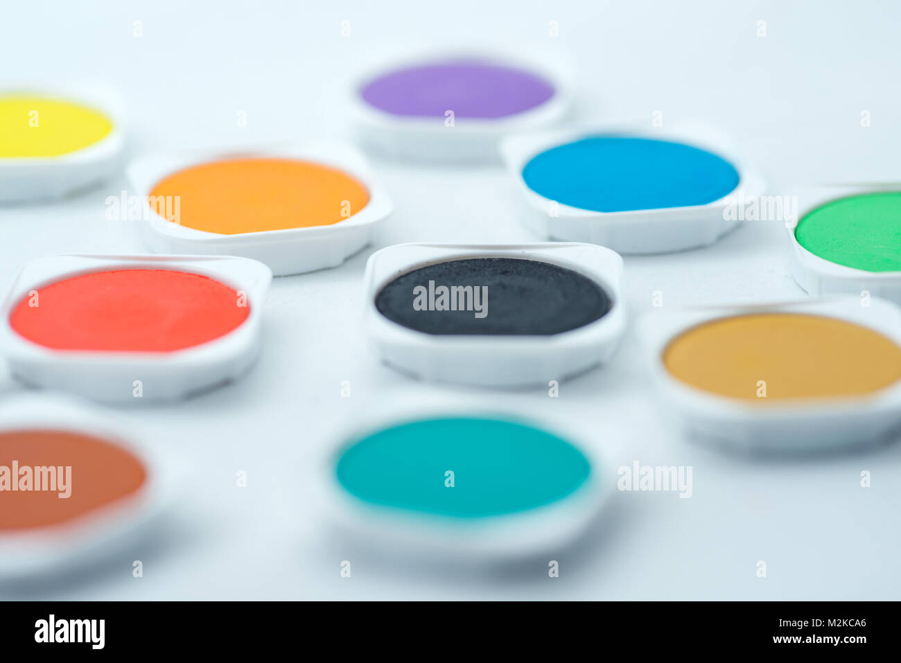 A bright palette of watercolor paints, high key lighting and shallow ...