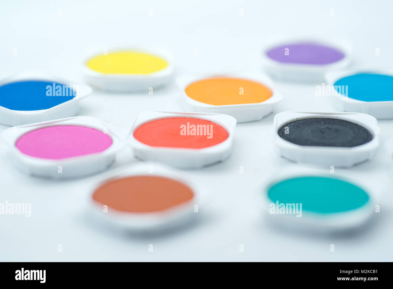 A bright palette of watercolor paints, high key lighting and shallow ...