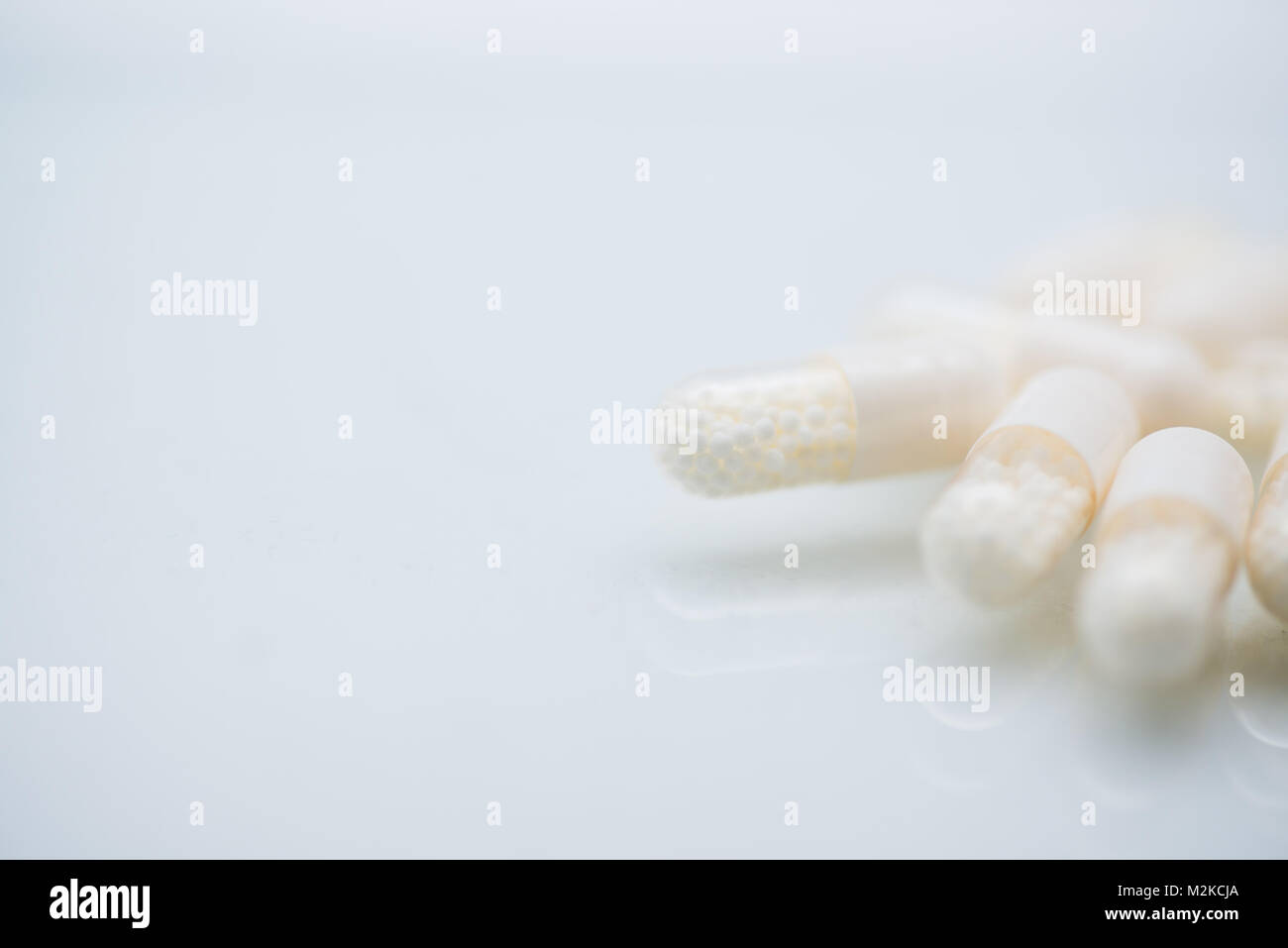 Close up of white capsule pills, pharmaceuticals, medicine, drugs or ...