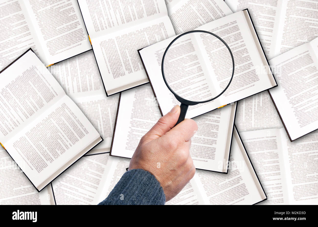 male hand and magnifier, concept for researching books text Stock Photo ...