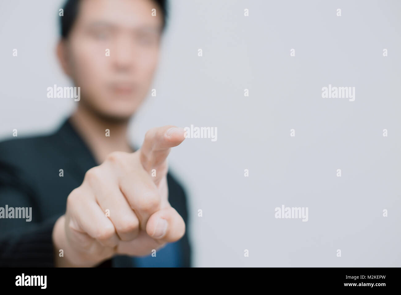 Asian business man pointing his finger to touch or order command on ...
