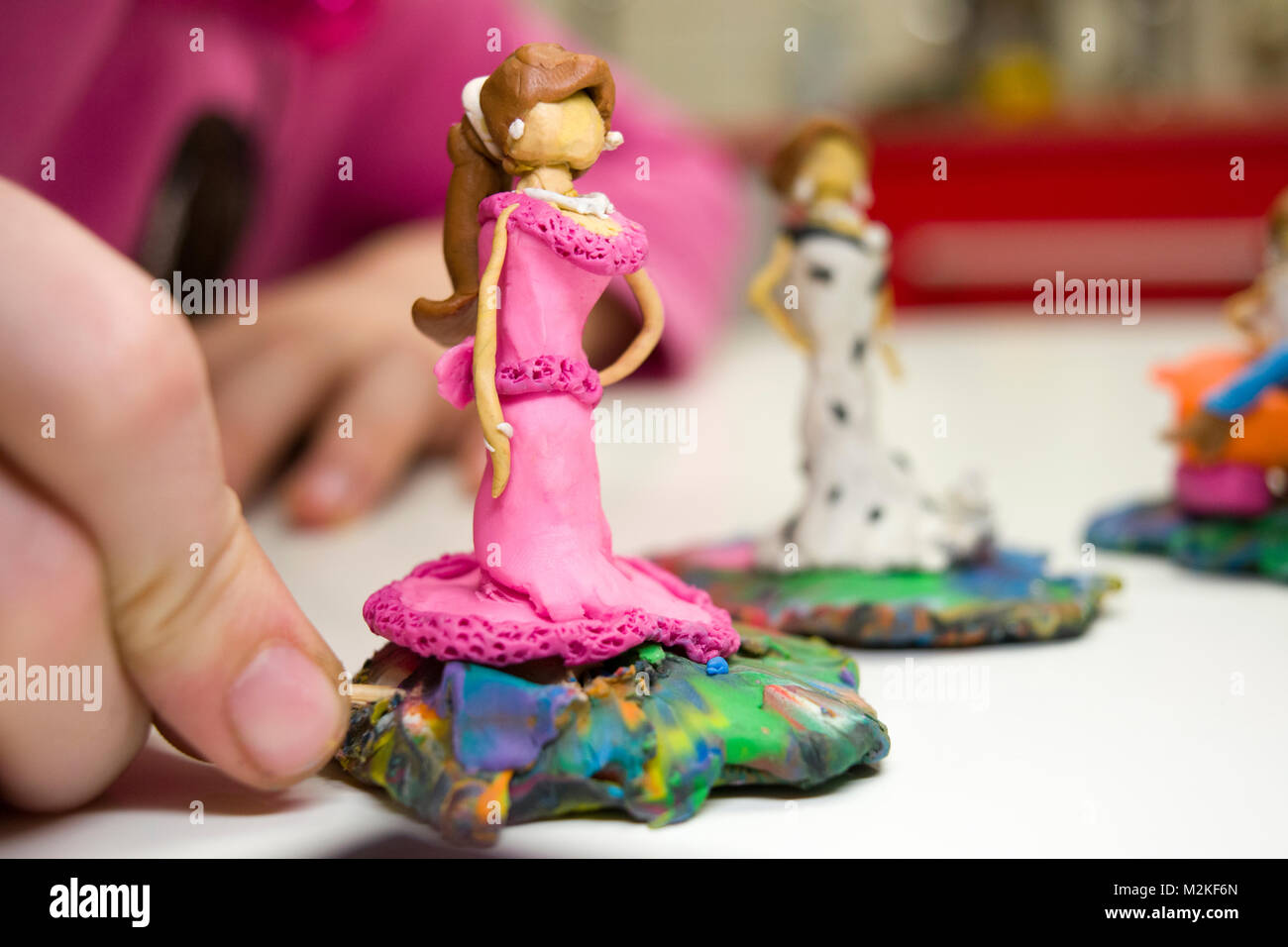 Colourful plasticine figures being created by little busy hands Stock ...